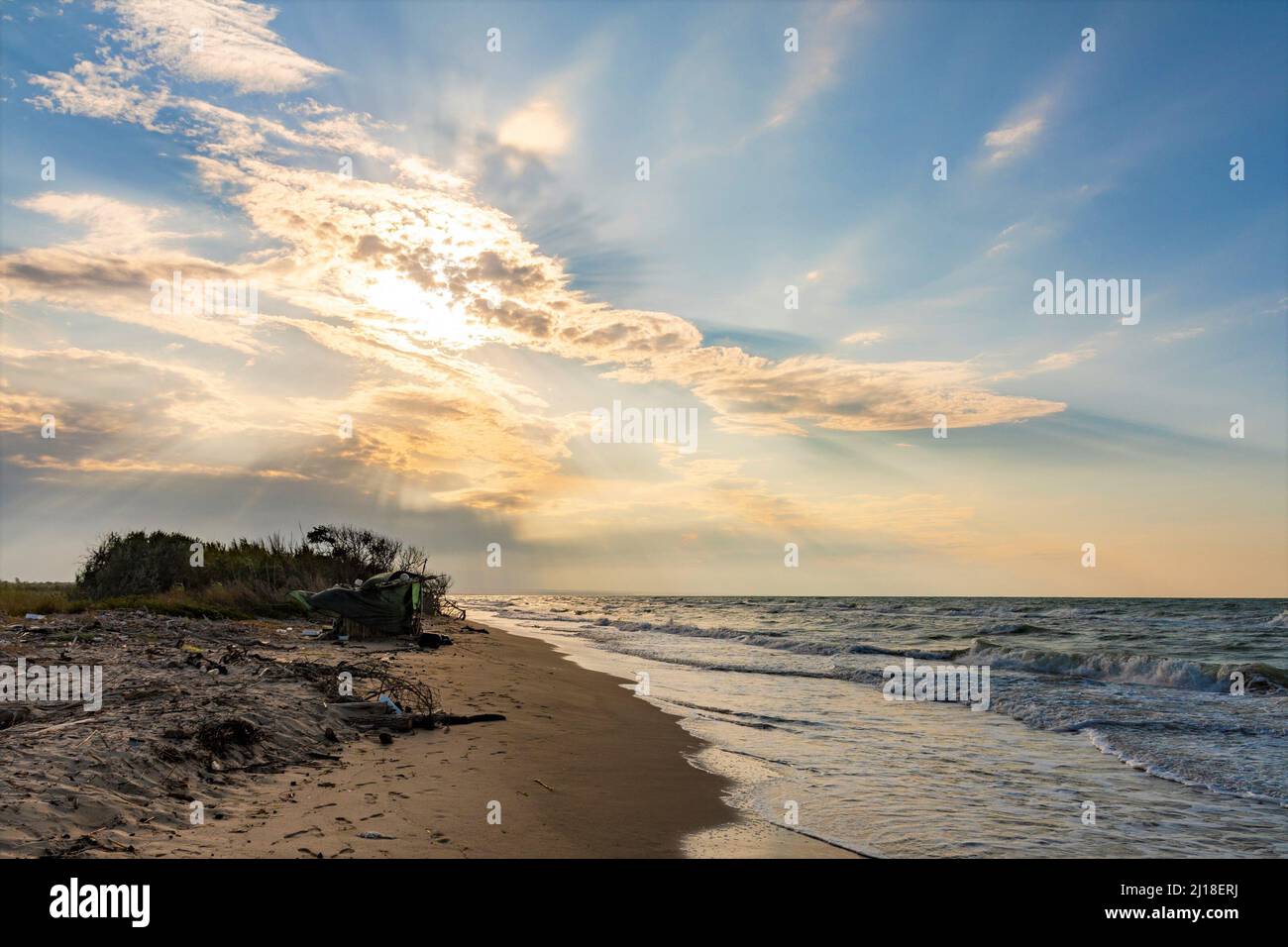Decaying seascape with litter abandoned on the beach Stock Photo - Alamy