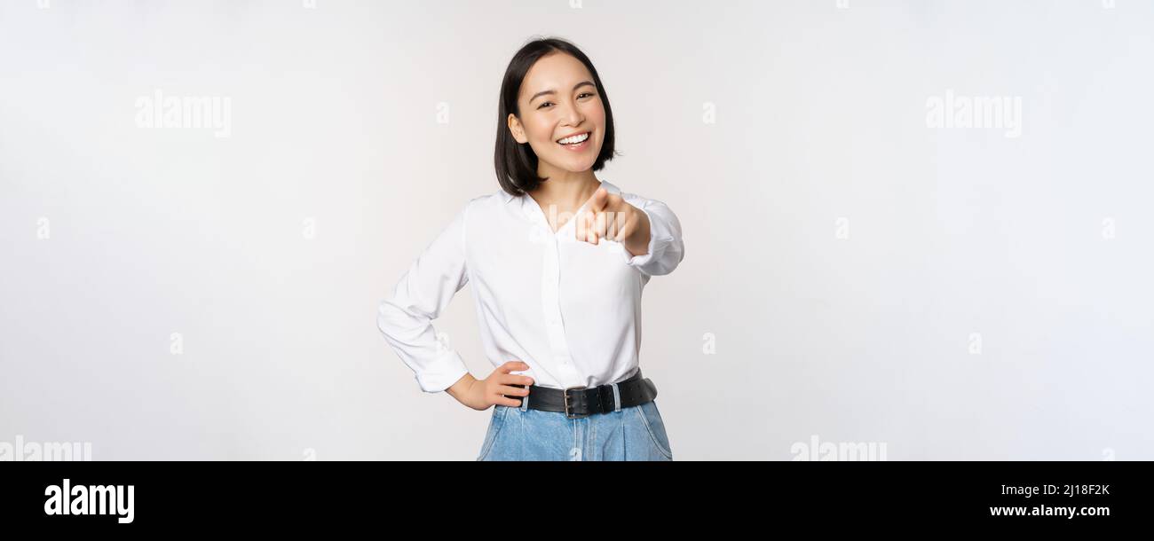 Its you. Beautiful young asian woman, company manager pointing finger ...