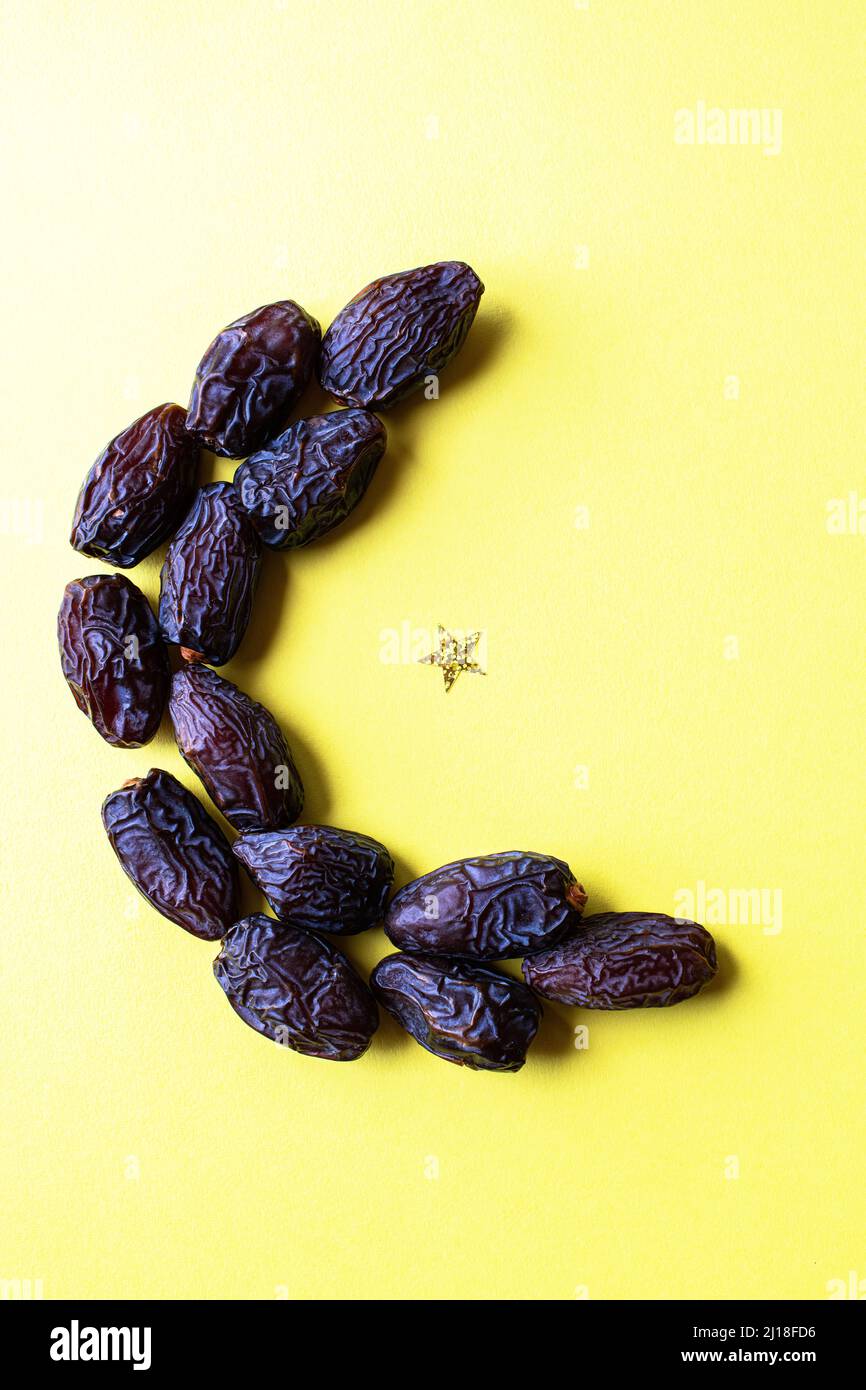 Shape of moon from dates and glowing glitter. Top view Stock Photo - Alamy