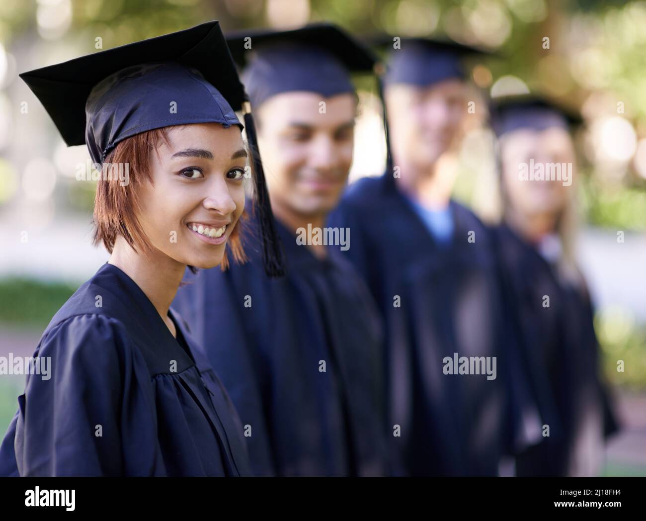 Excited for what is to come. A group of smiling graduates standing in a ...