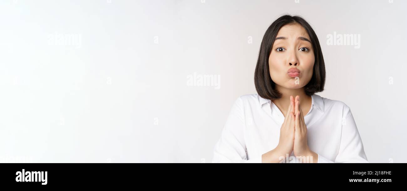 Cute asian woman begging, say please, asking for favour, need help ...