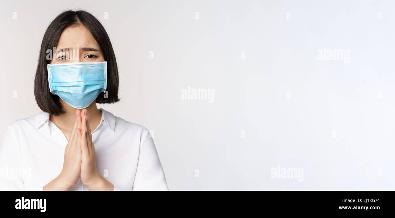 Portrait of asian woman in medical face mask from covid, begging ...