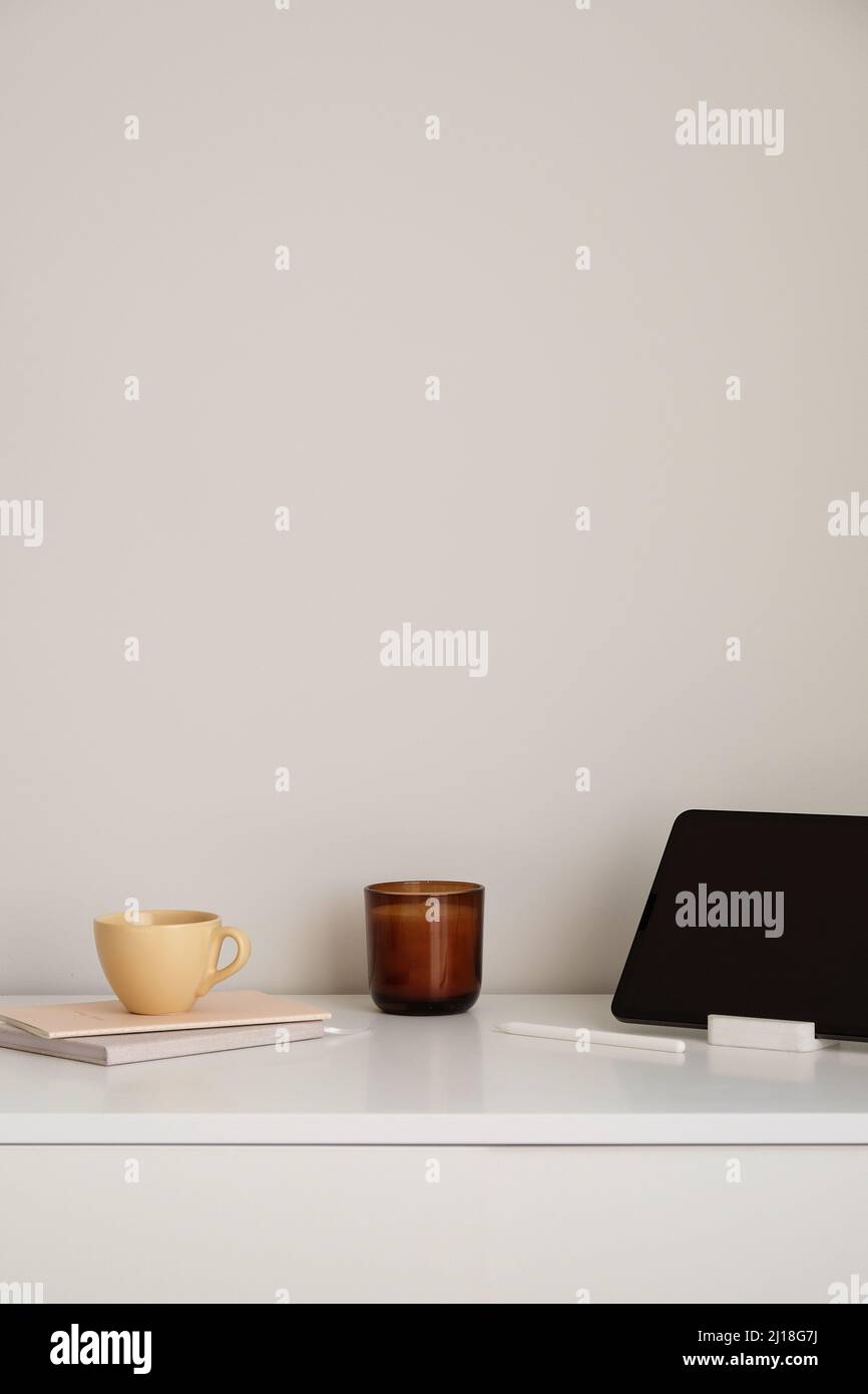 Minimalist home office desk table. Feminine workspace with mug of tea ...