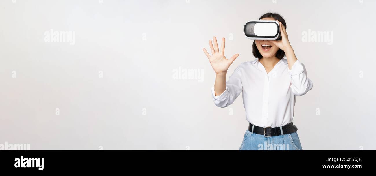 Vr chat. Asian girl saying hello in virtual reality glasses, smiling ...