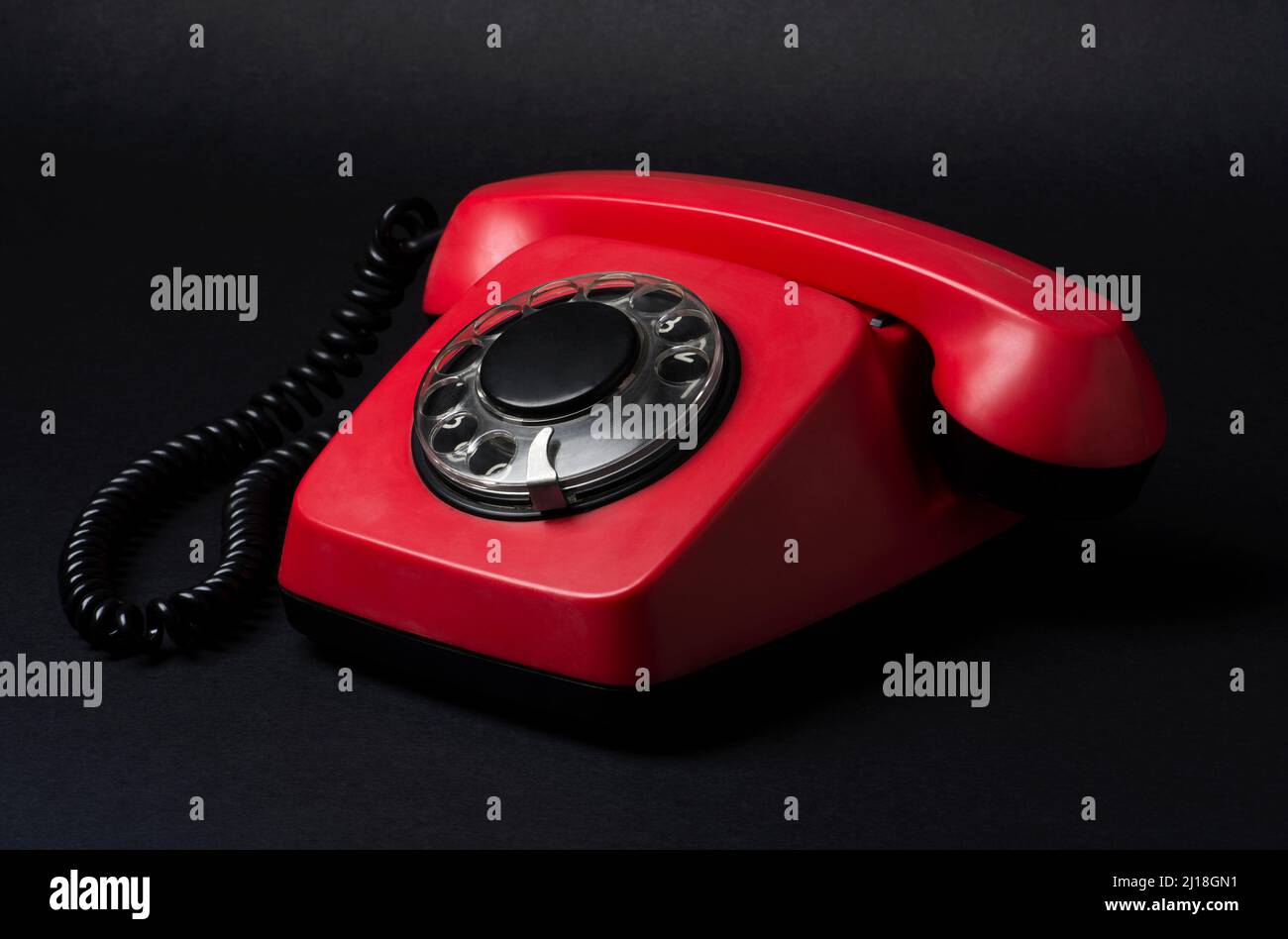 Retro red telephone on dark background Stock Photo - Alamy