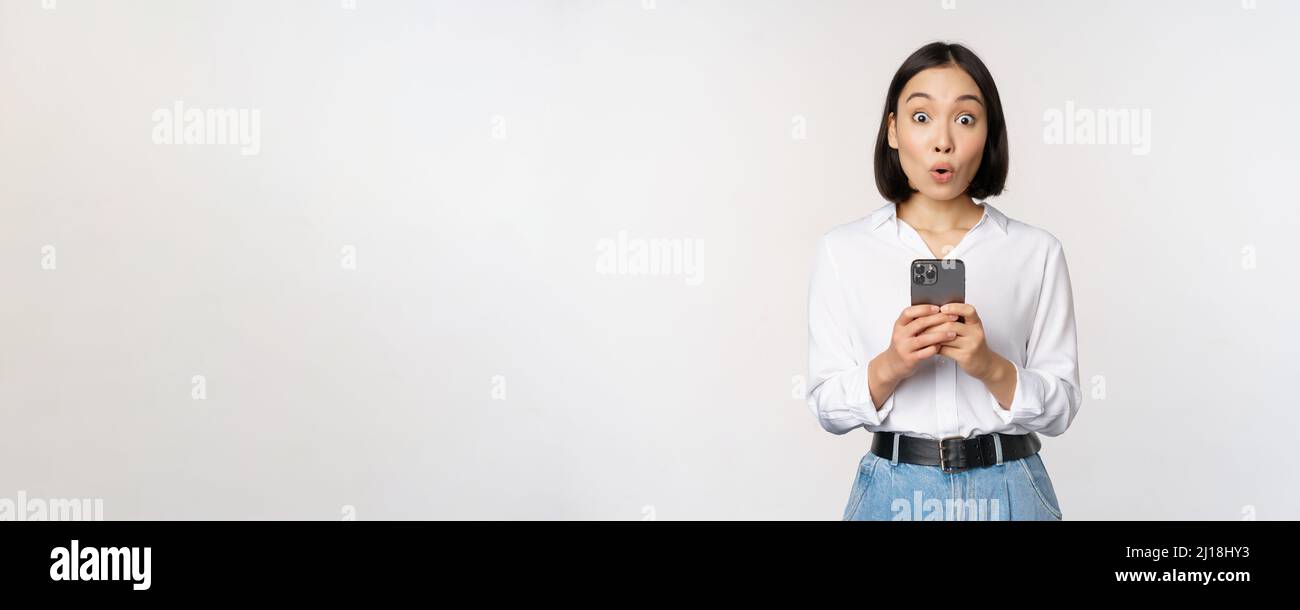 Technology concept. Portrait of asian woman with mobile phone, girl ...