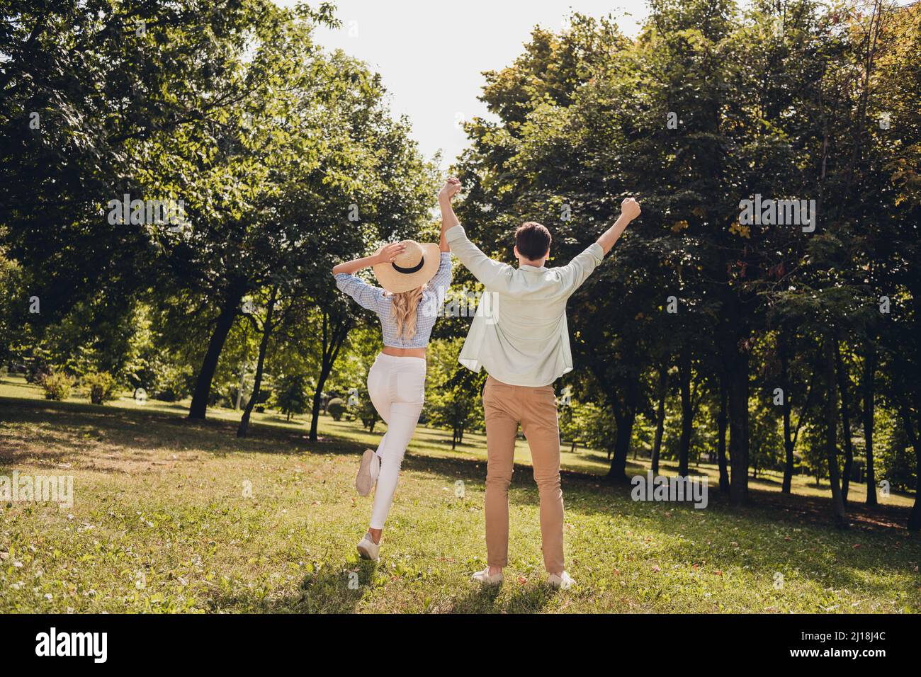 Rear back behind full length body size view of two attractive adorable ...