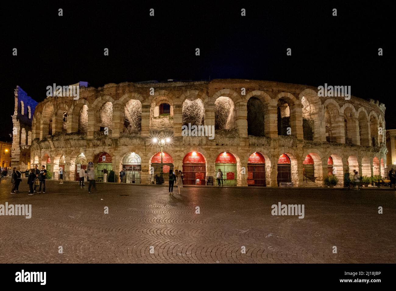 A closeup of Tourists around the Verona Roman arena at night, Italy ...