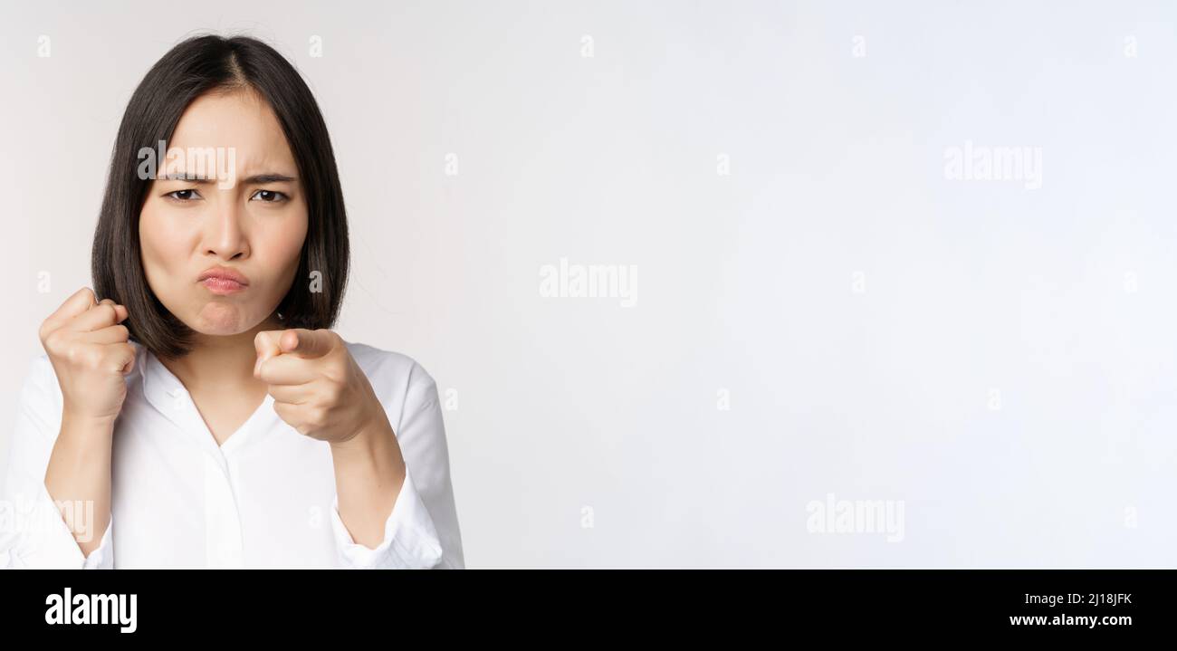Close up of angry young woman clench fists, ready for fight, fighting ...