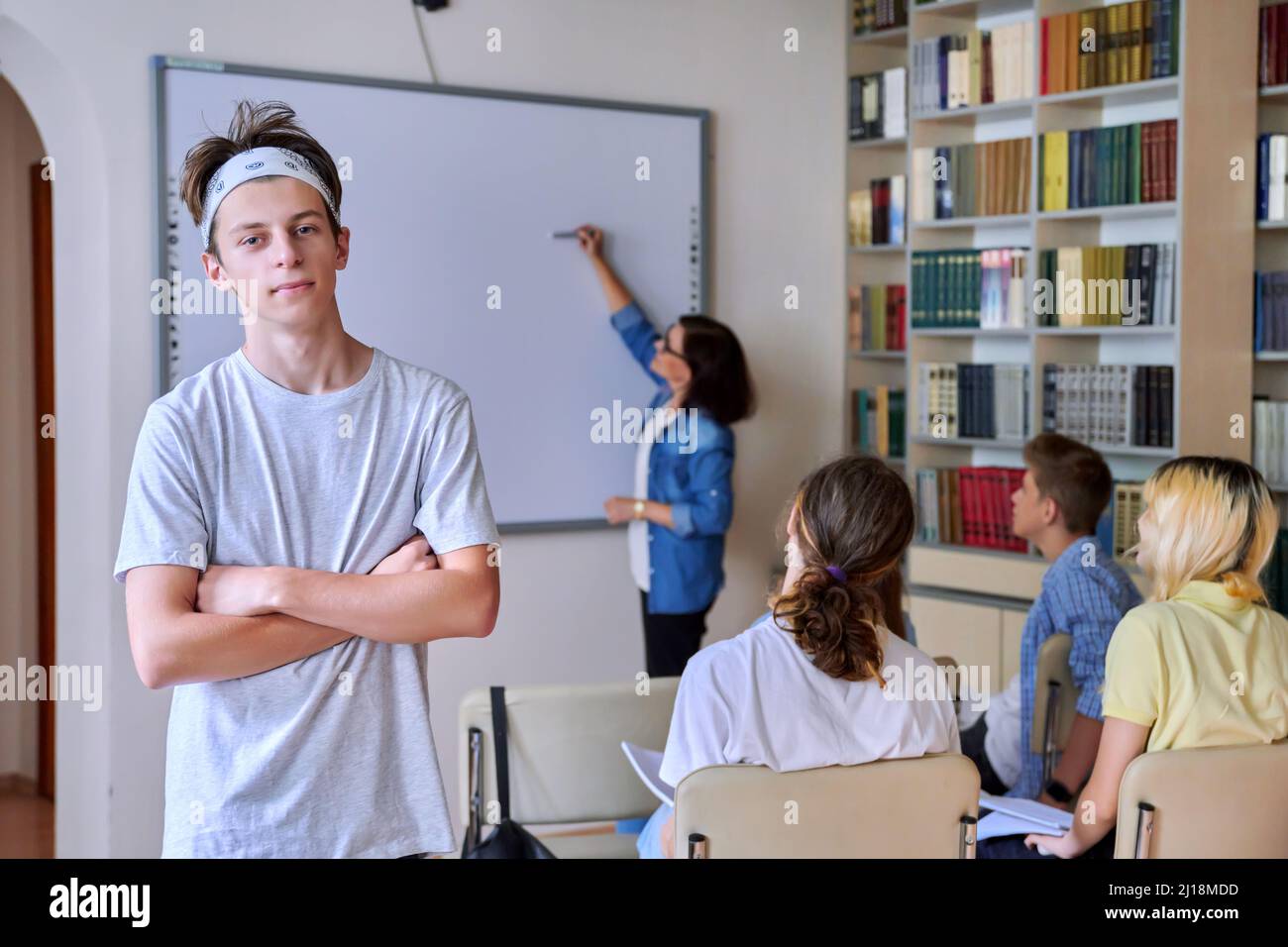 Teenage guy in the classroom looking at the camera Stock Photo - Alamy