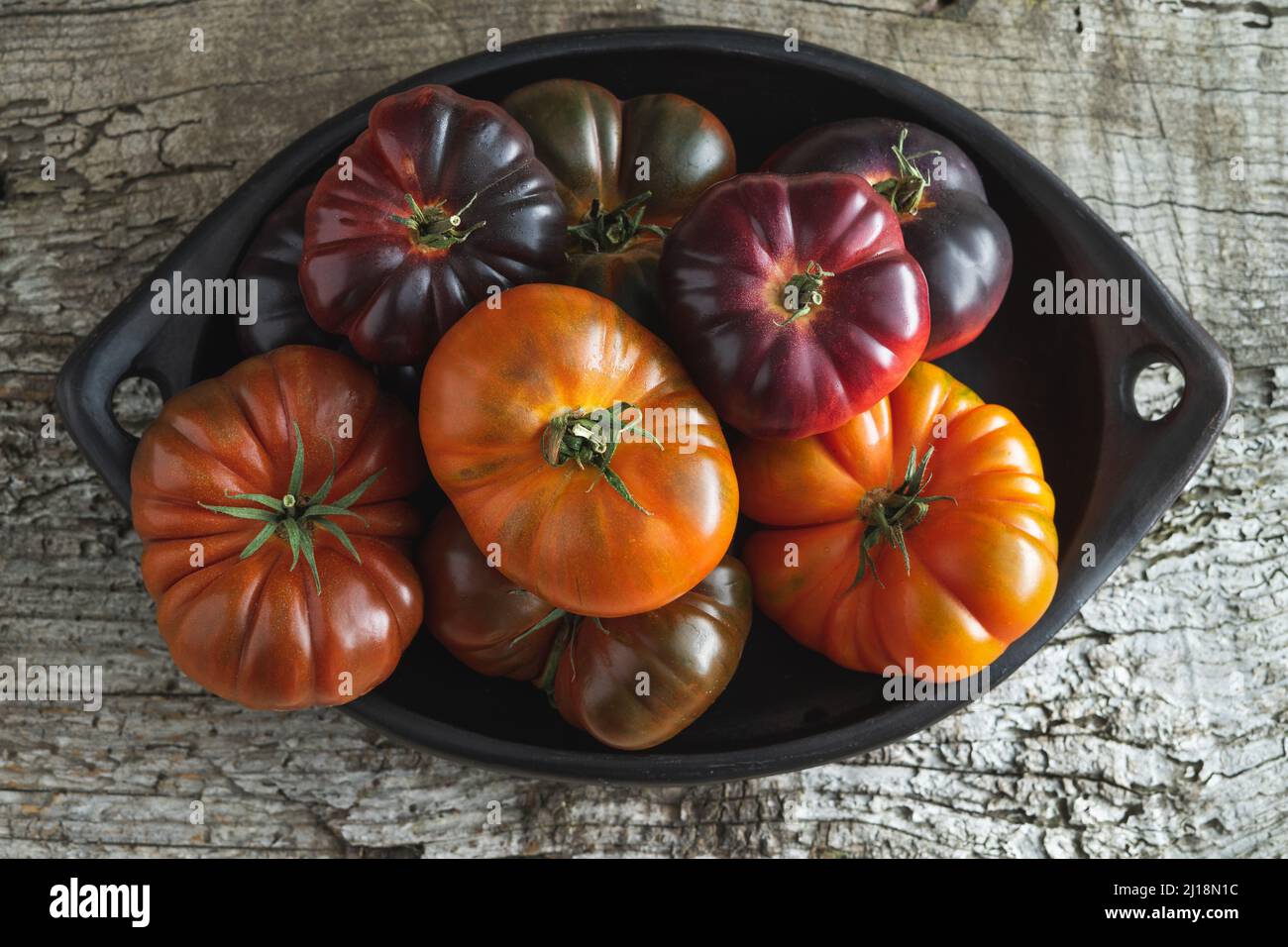 Tray with raf tomatoes and blue sea on old wood background. Copy space ...