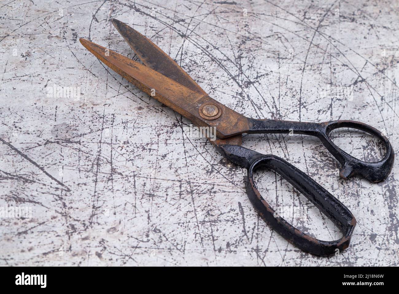 The photo shows an old rusty scissors on grey, used background Stock ...