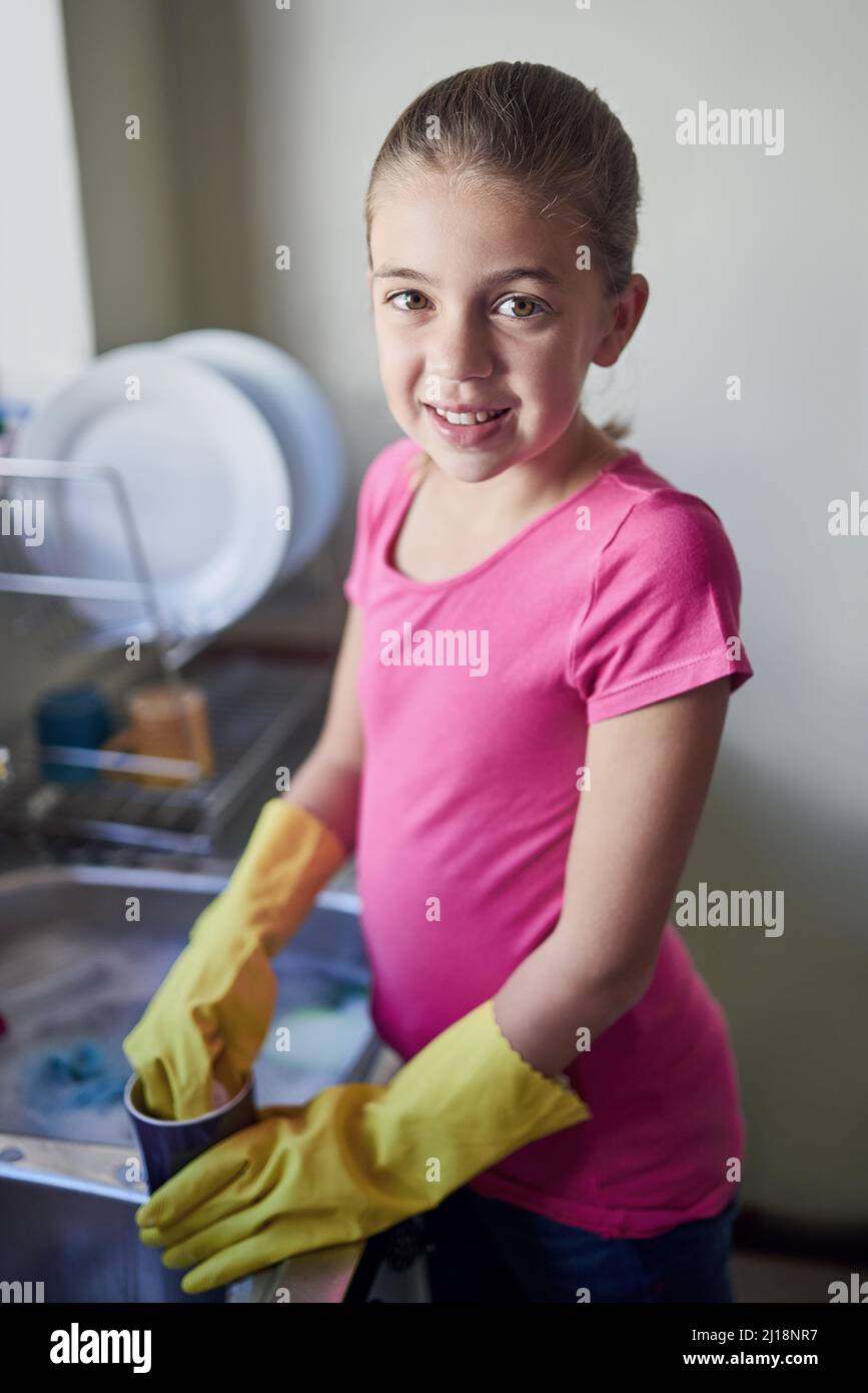 Making sure the dishes are squeaky clean. Portrait of a young girl ...