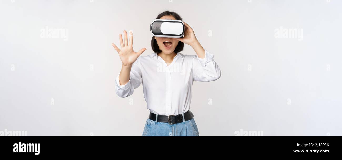 Vr chat. Asian girl saying hello in virtual reality glasses, smiling ...
