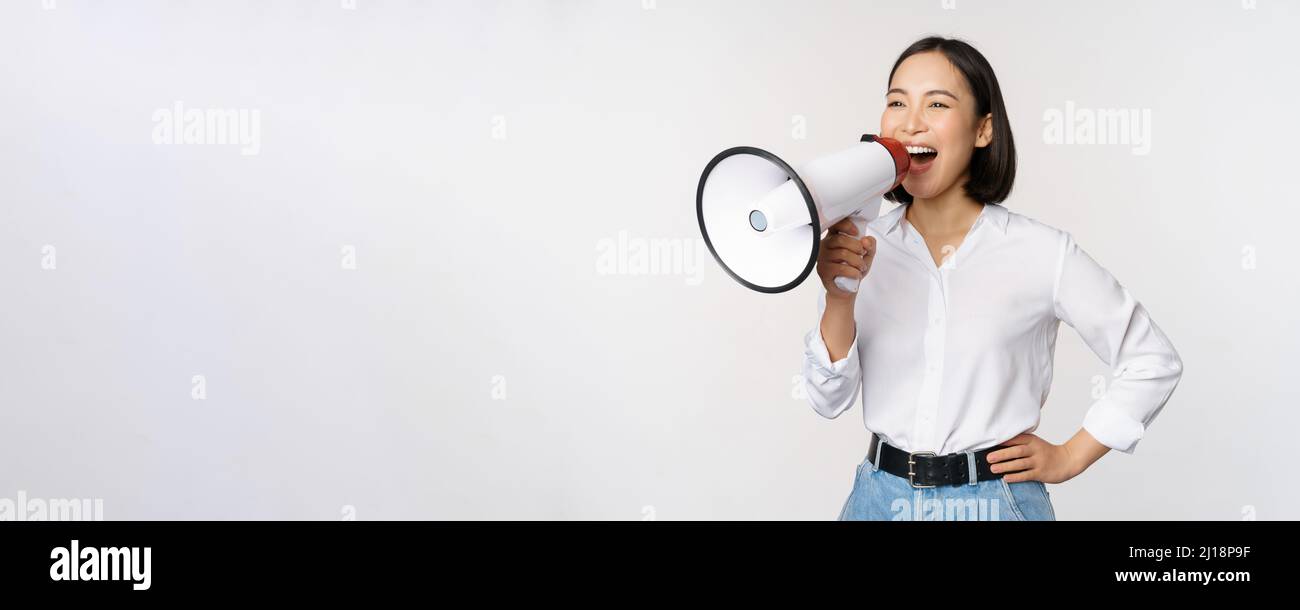 Image of young woman, korean activist, recruiter screaming in megaphone ...