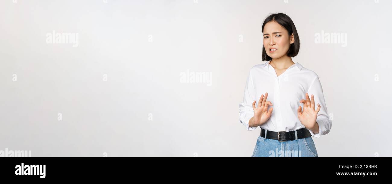 No thank you. Young disgusted asian woman declining proposal, shaking ...