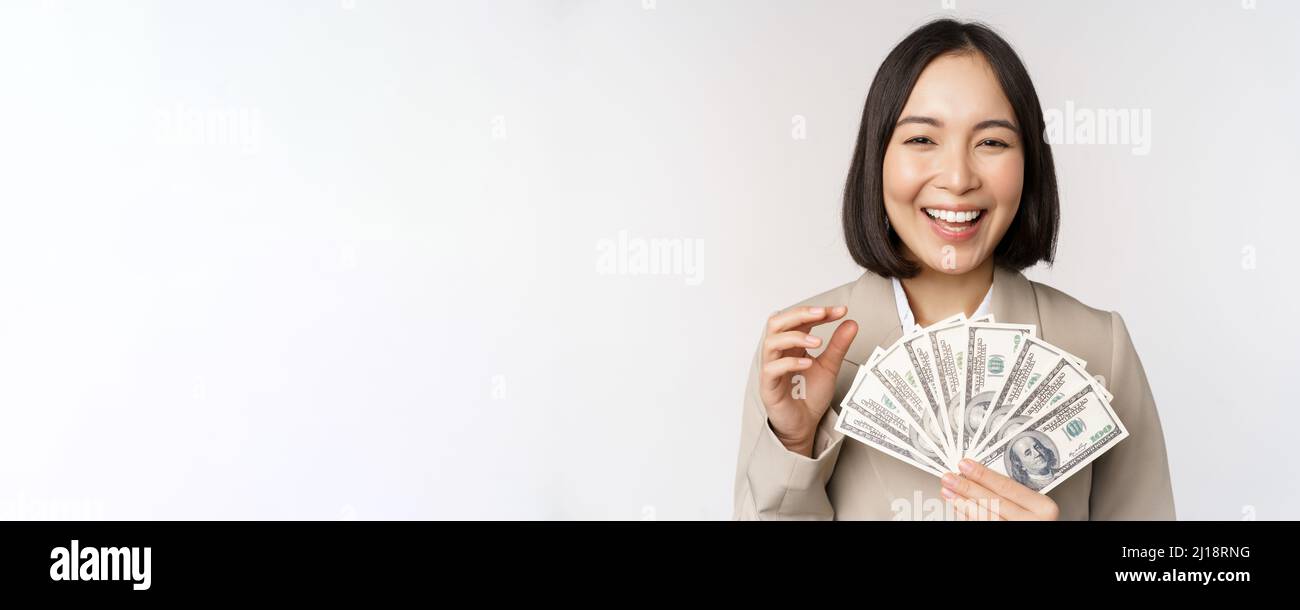 Image of successful businesswoman holding money. Asian corporate woman ...