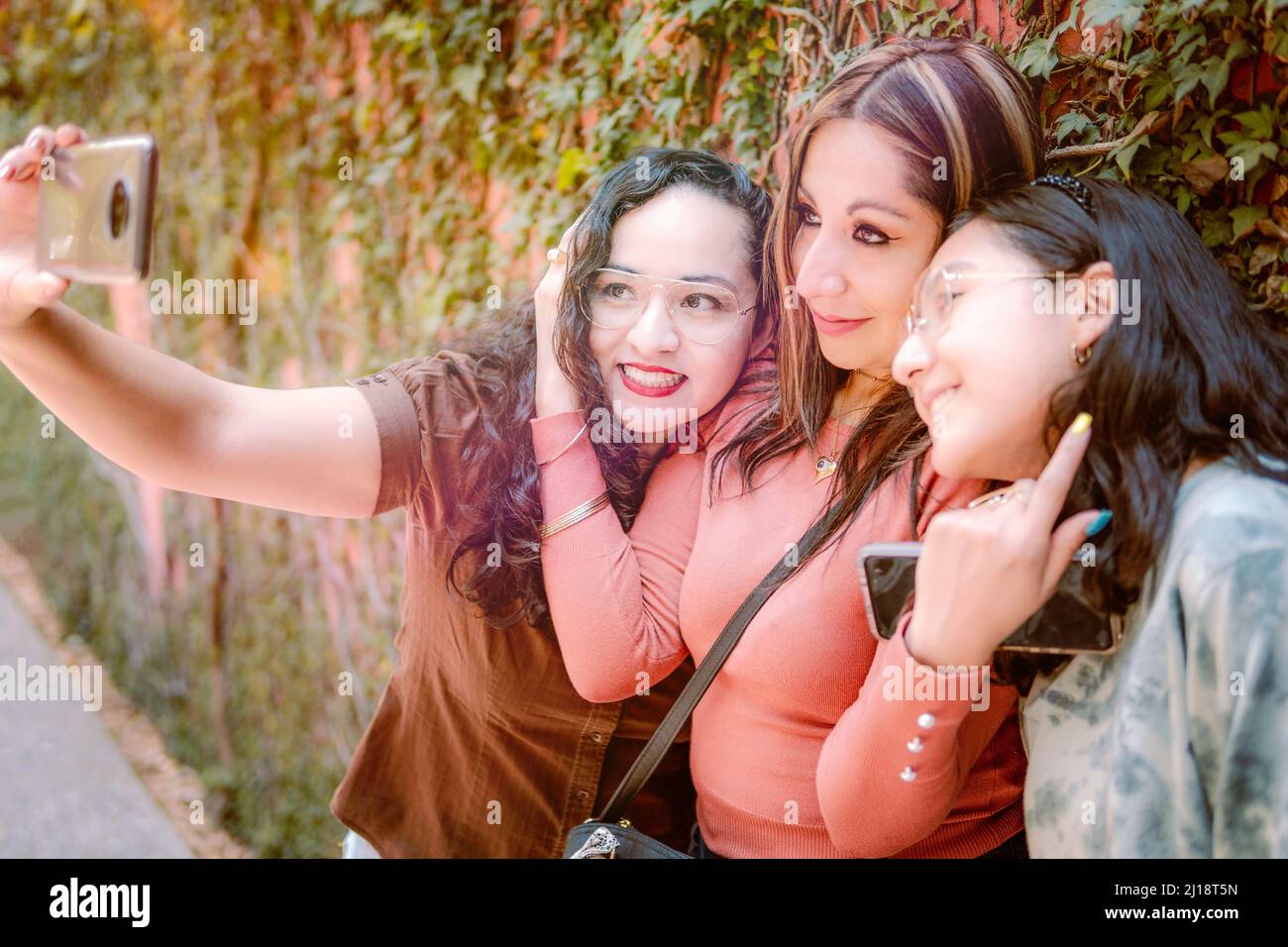 Three Girls Taking Selfie In The Street Looking Happy Because They