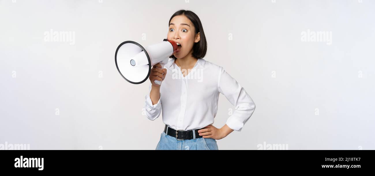 Image of young woman, korean activist, recruiter screaming in megaphone ...