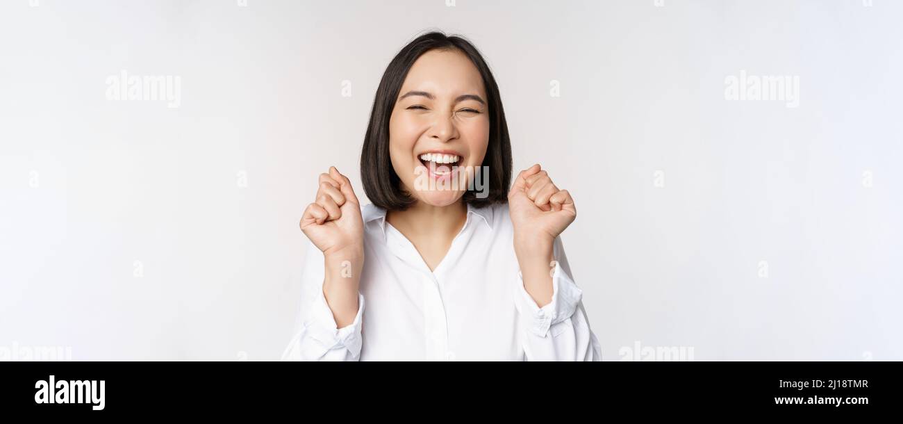 Close up face portrait of dancing asian woman smiling, triumphing and ...