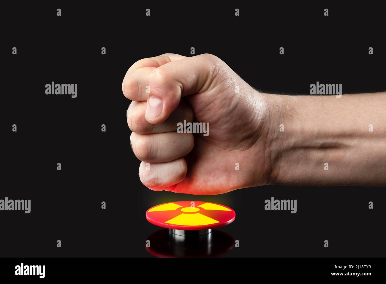 The hand presses the big red button. The concept of the threat of ...