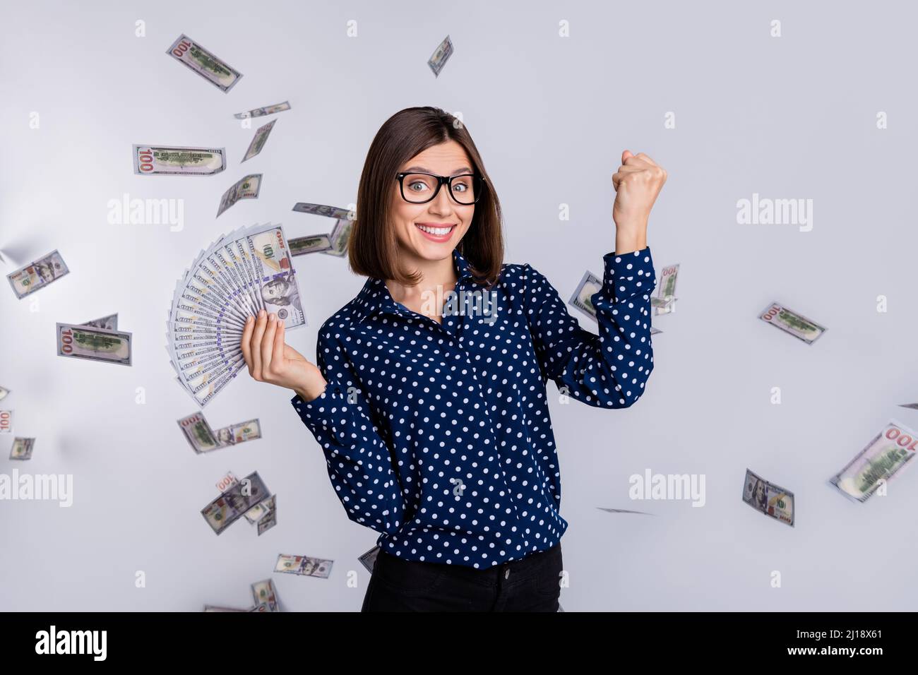 Photo of positive lady raise fist hold cash fan win million dollars ...