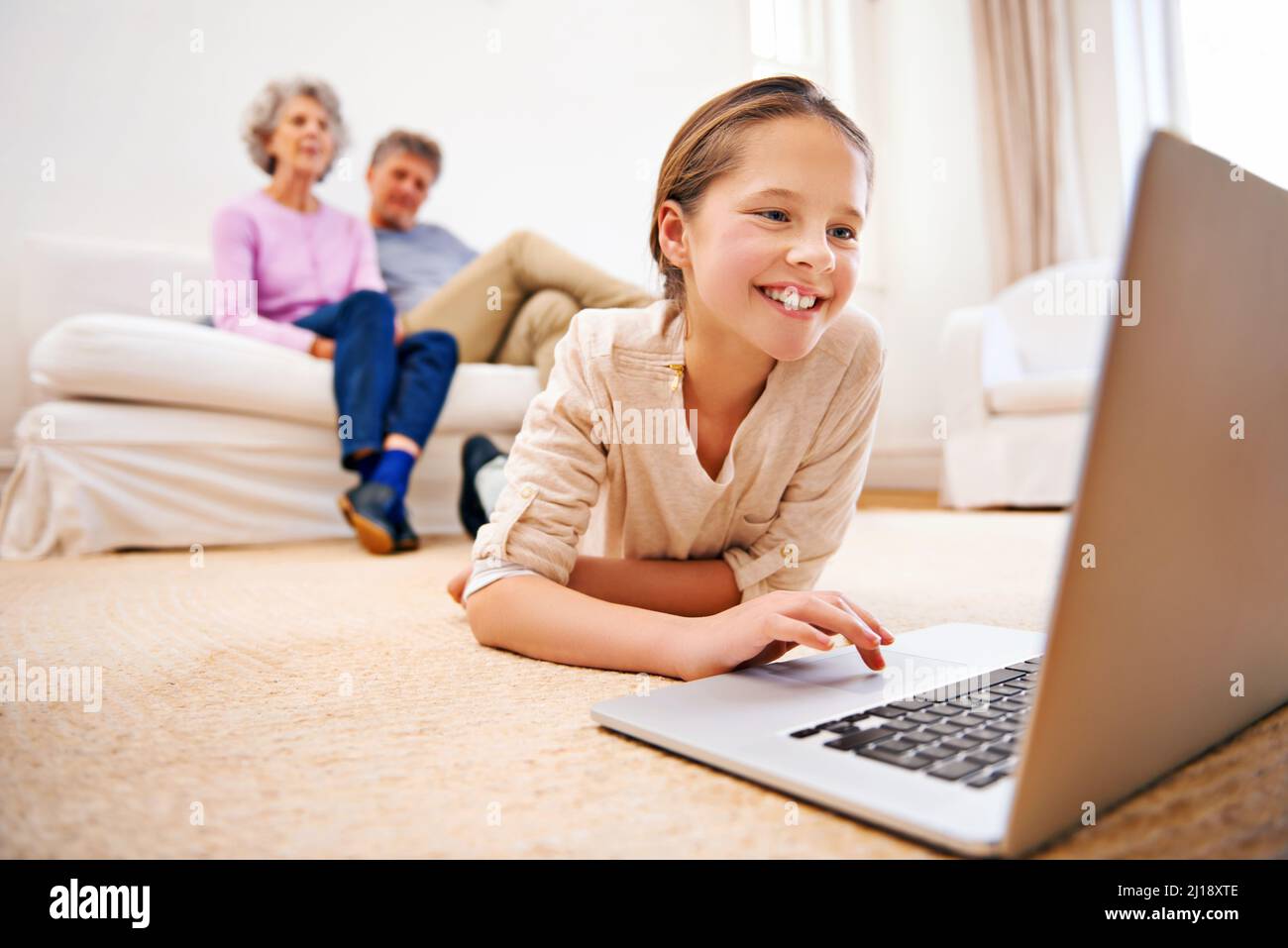 She keeps herself entertained everywhere. Shot of grandparents watching ...
