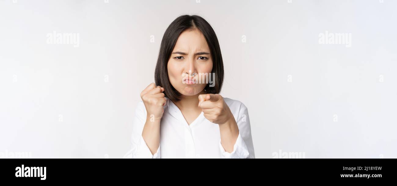 Close up of angry young woman clench fists, ready for fight, fighting ...