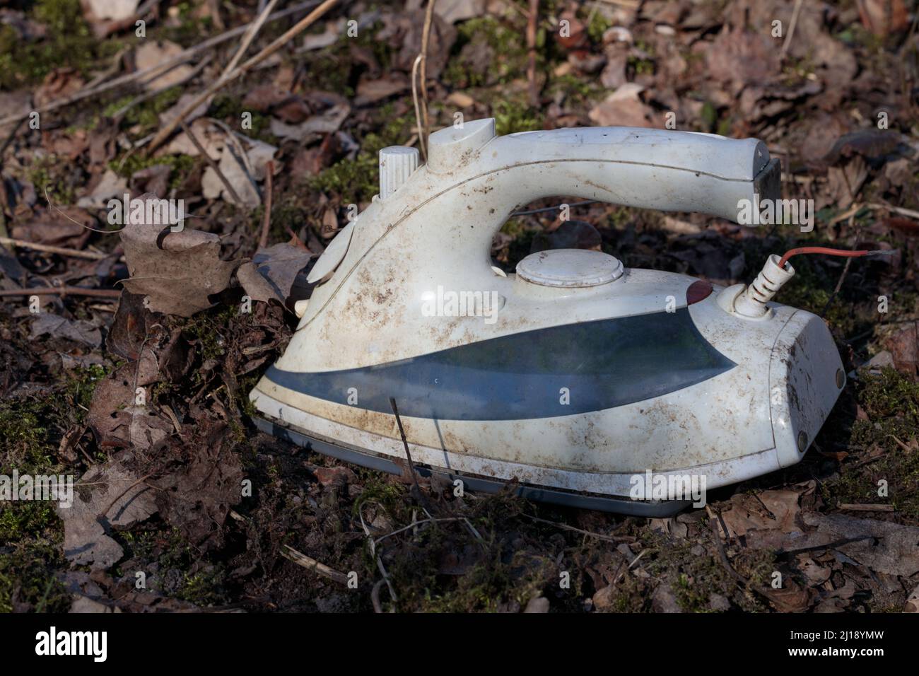 Old ironing iron, abandoned. The problem with electro-waste. Illegal ...