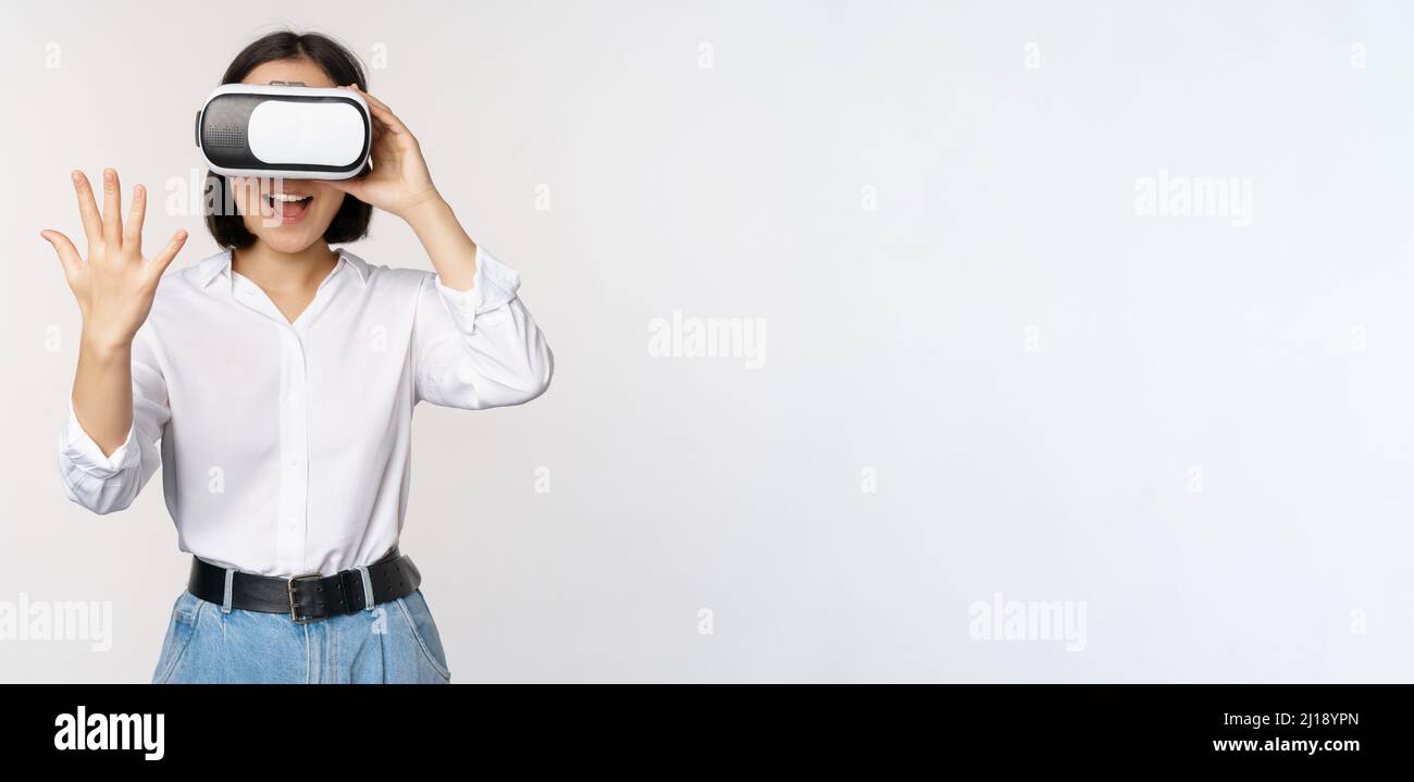 Vr chat. Asian girl saying hello in virtual reality glasses, smiling ...