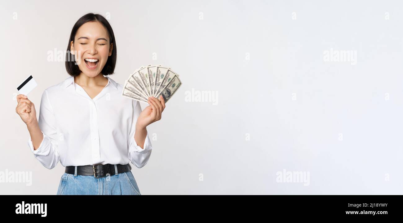 Finance and money concept. Happy young asian woman dancing with cash ...