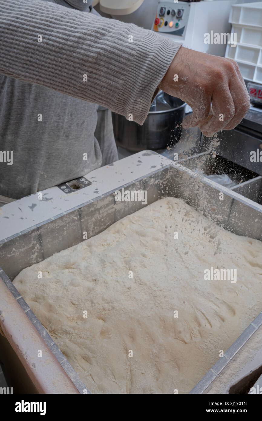 Artisan baker and pastry chef. Detail of baker chef's hands preparing ...