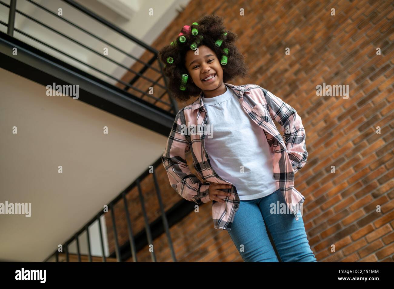 Bottom view of girl smiling at camera at home Stock Photo - Alamy