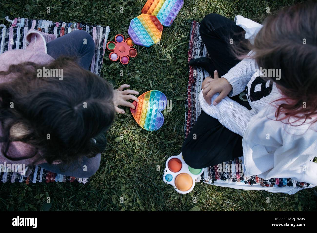 Children pull hands to pop it toys Stock Photo - Alamy