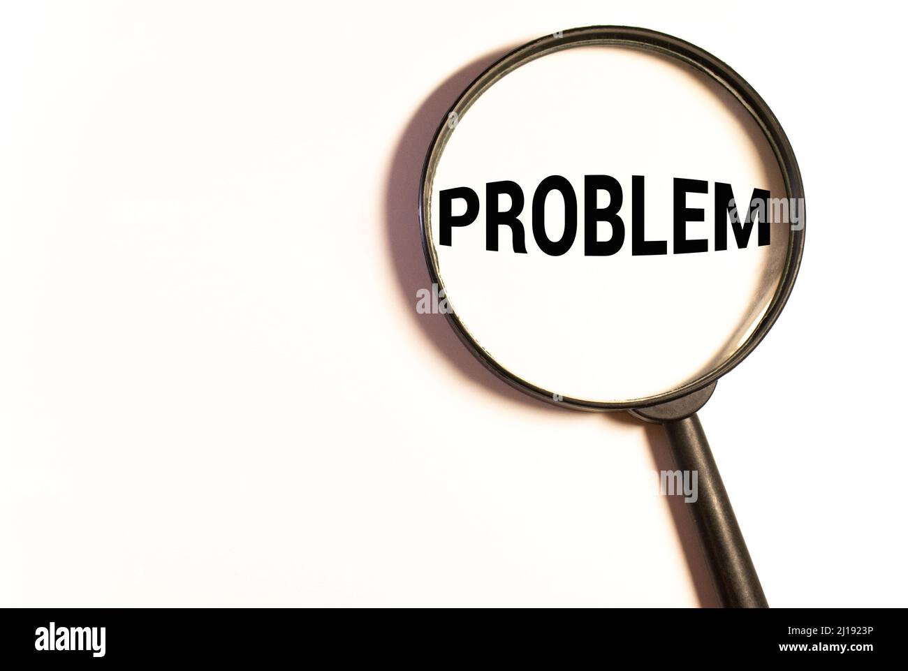 Magnifying glass with text concept word PROBLEMS on a dark table and a ...