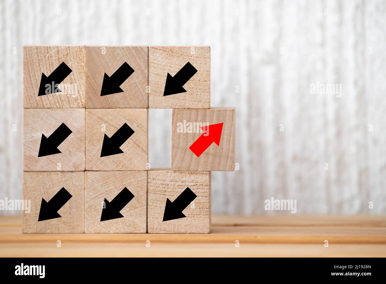 Wood cube presents red arrow facing opposite direction, Concept of ...
