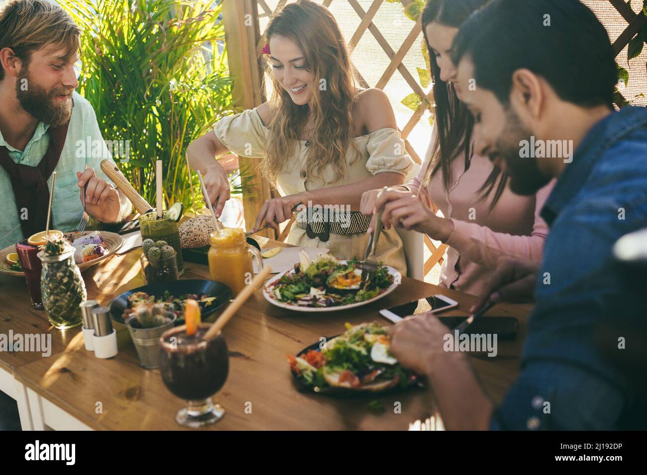 Young friends having fun eating brunch at healthy food restaurant ...