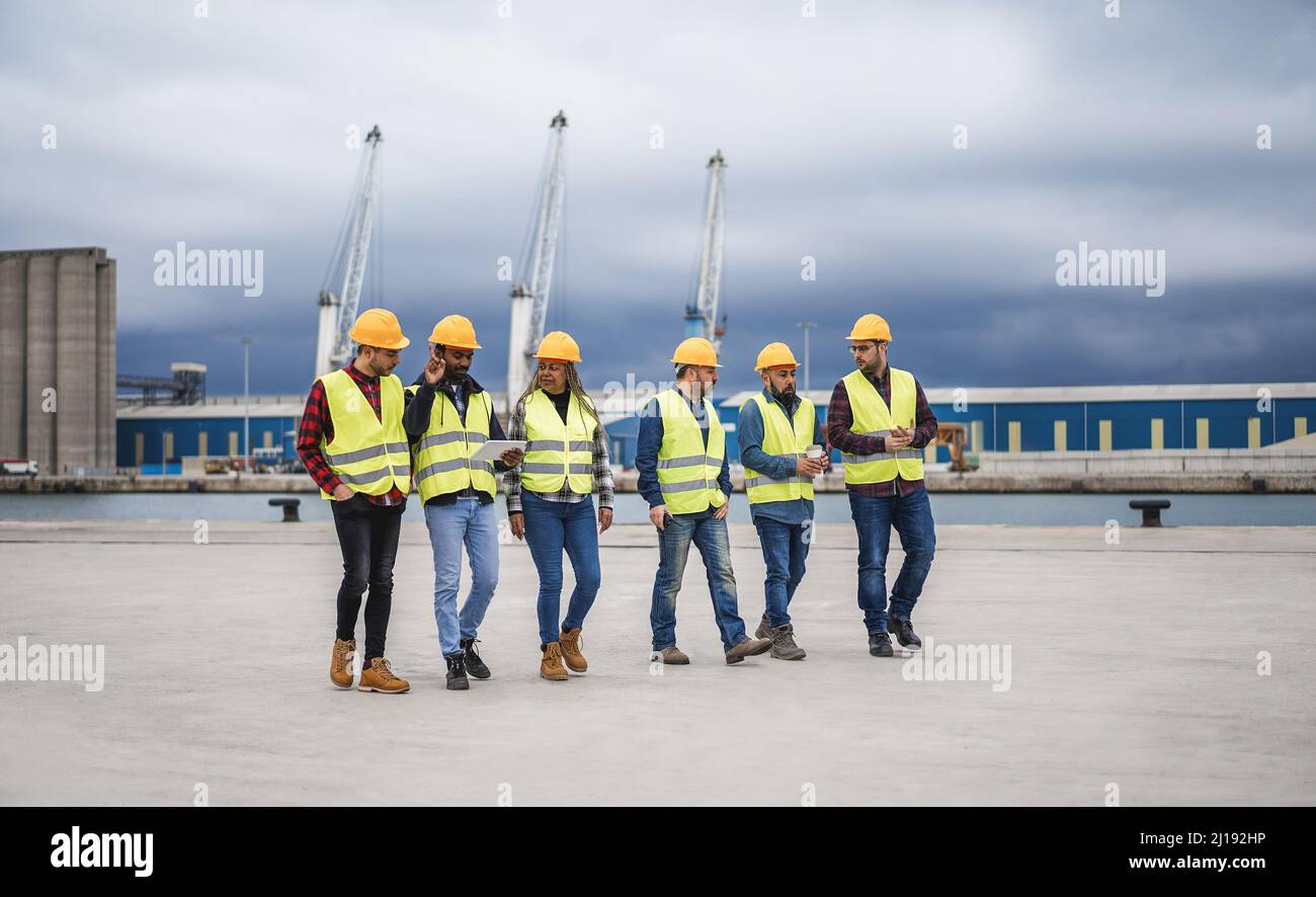 Multiracial people working together at industrial port outdoor - Focus ...