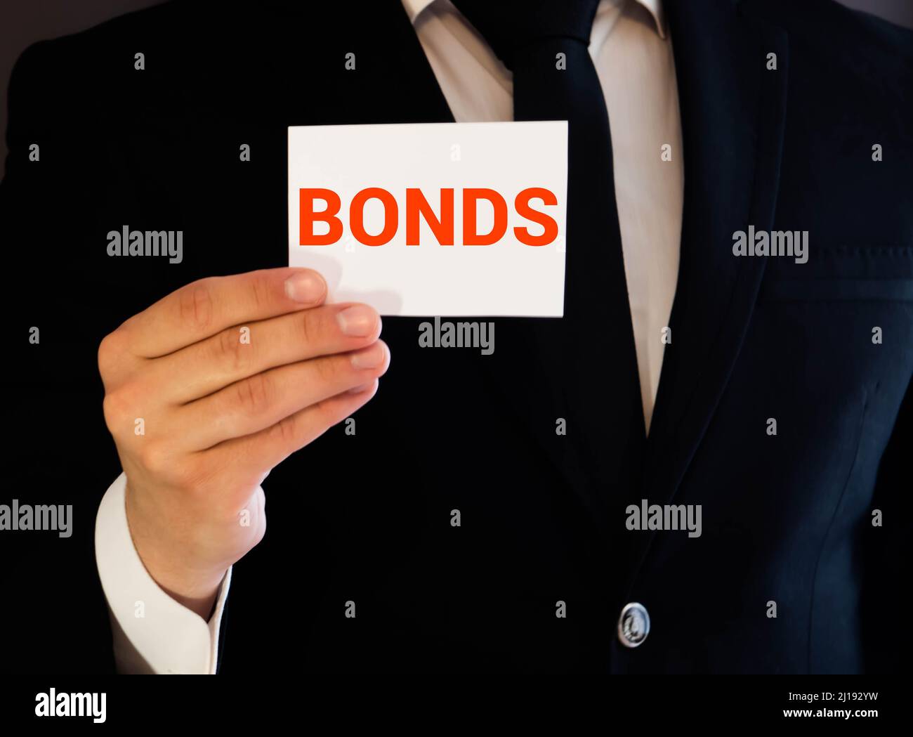 Man holding brochure with BONDS text on grey background. Mock up for ...
