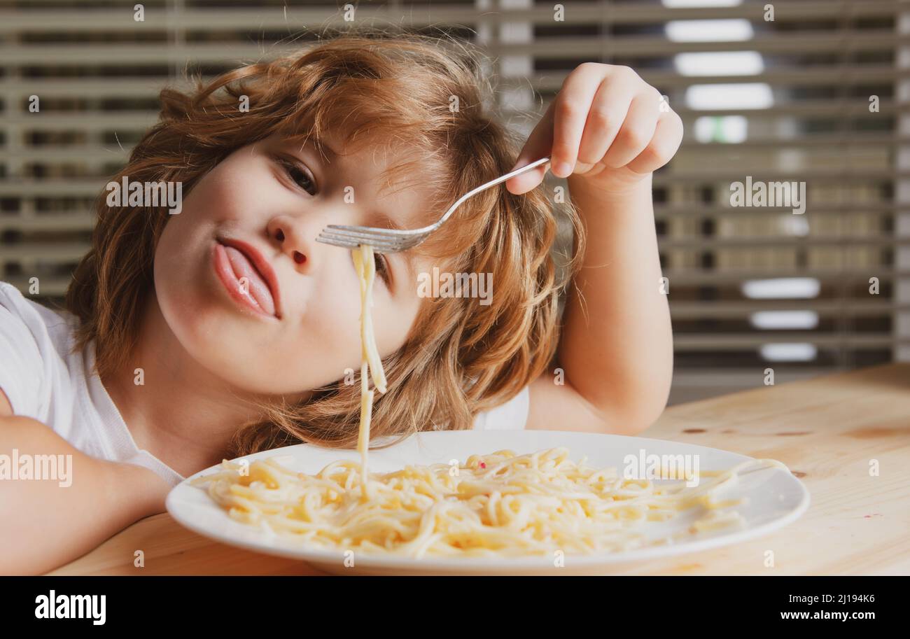 Portrait of a cute child boy. Close up caucasian kid eating pasta ...