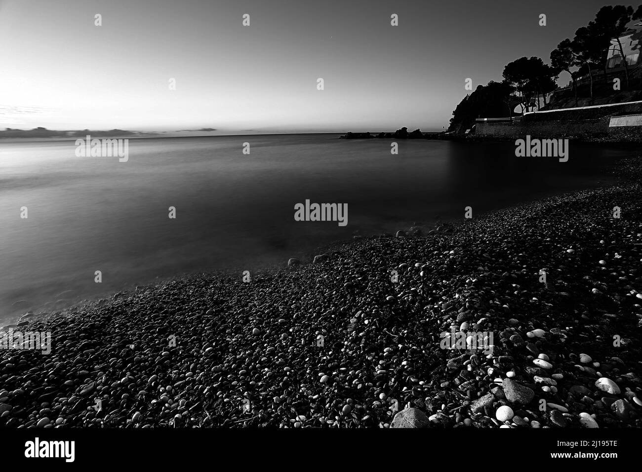 A grayscale shot of a rocky beach Stock Photo - Alamy