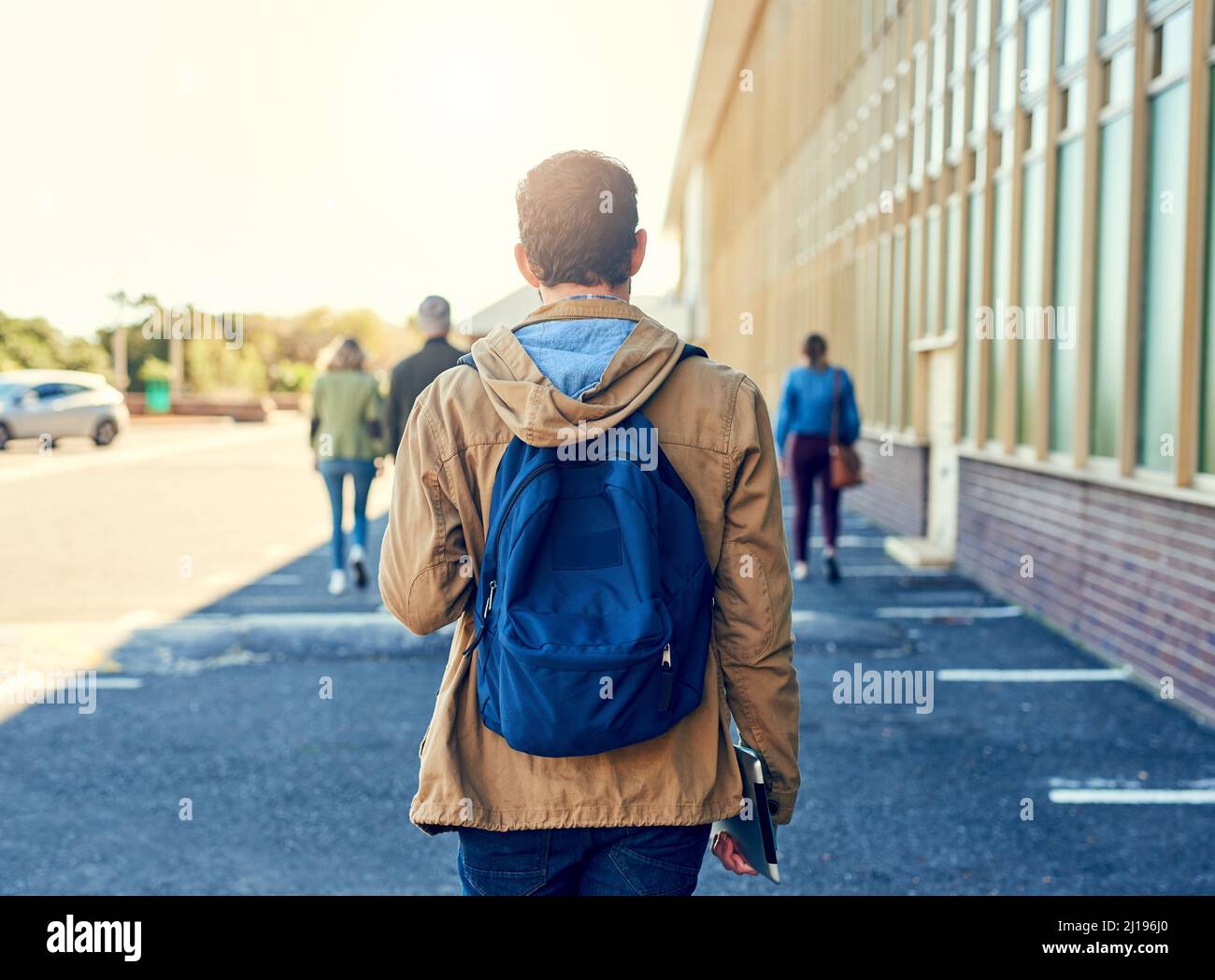 On my way to class. Shot of a college student between classes on campus ...