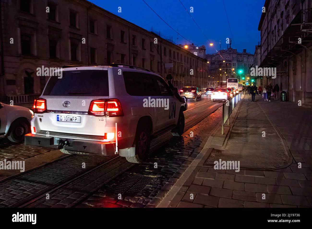 A UN SUV drives in traffic at night. (Photo by Ty O'Neil / SOPA Images ...