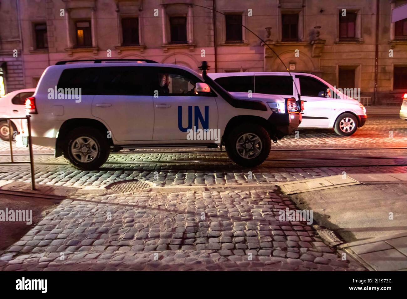 Two men sit in a vehicle marked UN at night. (Photo by Ty O'Neil / SOPA ...