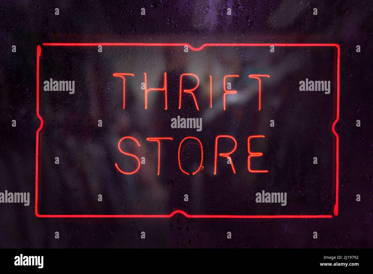 Vintage Neon Thrift Store Sign in Rainy Store Window Stock Photo - Alamy