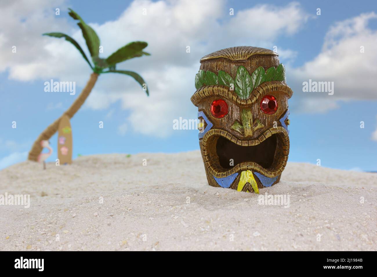 Antique Mask From Hawaii on Beach With Flowers Stock Photo - Alamy