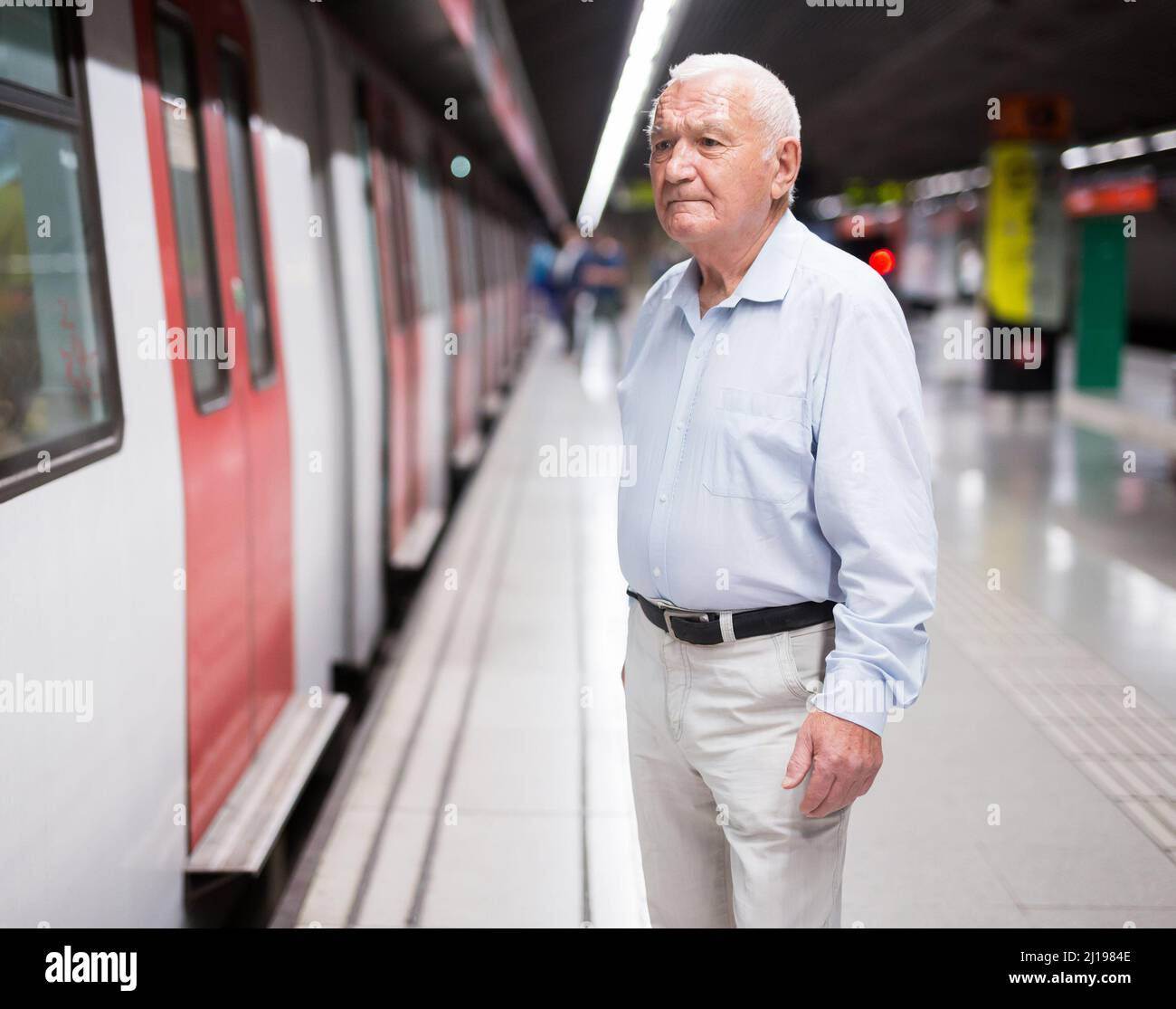 Elderly man in metro station Stock Photo - Alamy