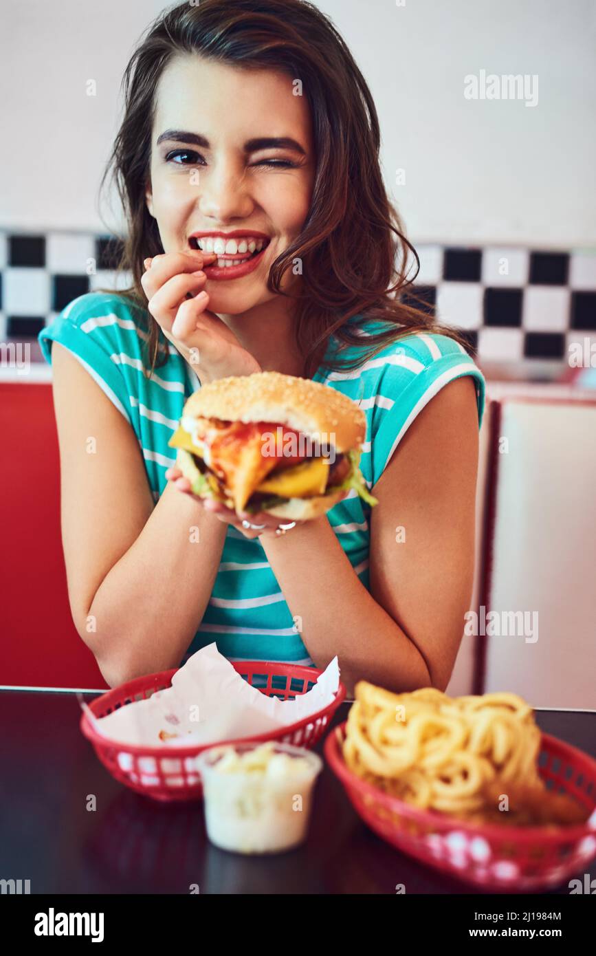 I eat very well. Cropped portrait of an attractive young woman enjoying ...