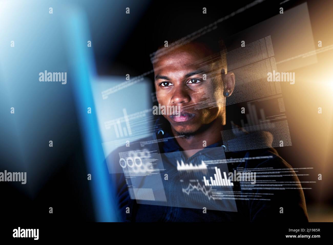 Analysing the information. Cropped shot of a young male programmer sifting through data streams ...