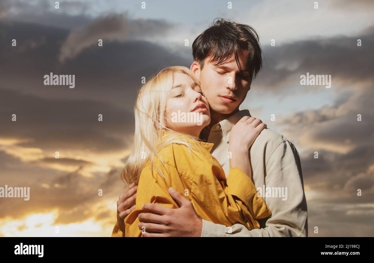 Portrait of lovely couple in love on sunset. Young sensual girlfriend glad to passionate kiss ...